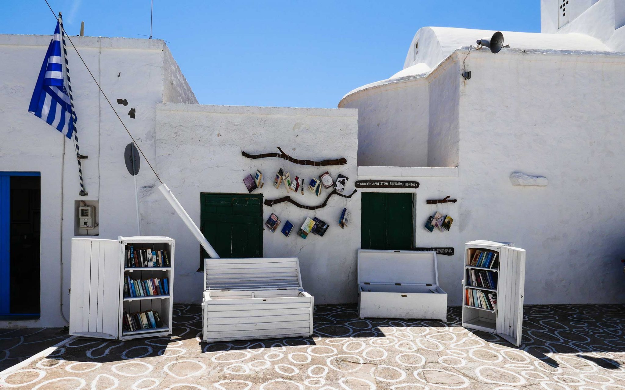 kimolos_flag_bookshop_shutter - Greece Is